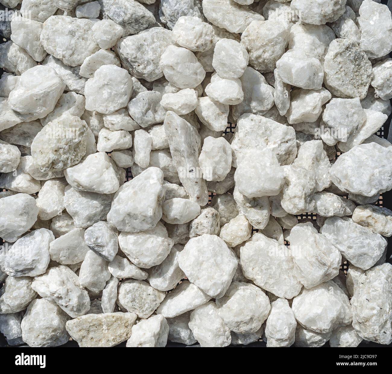 White salty rough stones. Many small stones of rough structure, white ...