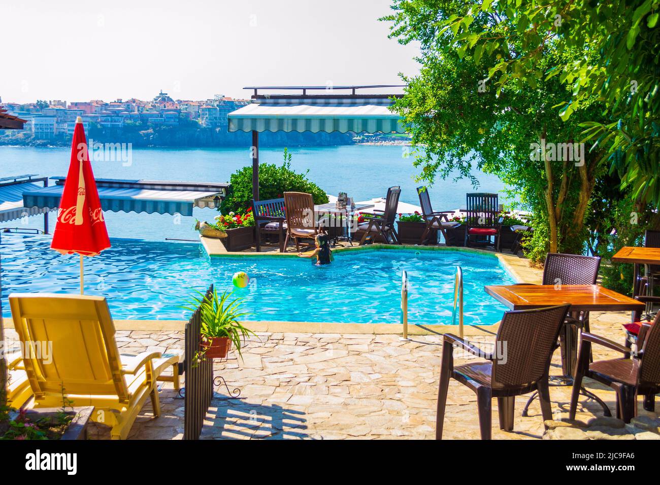 Patio with blue pool and outdoor seating overlooking the beautiful ...