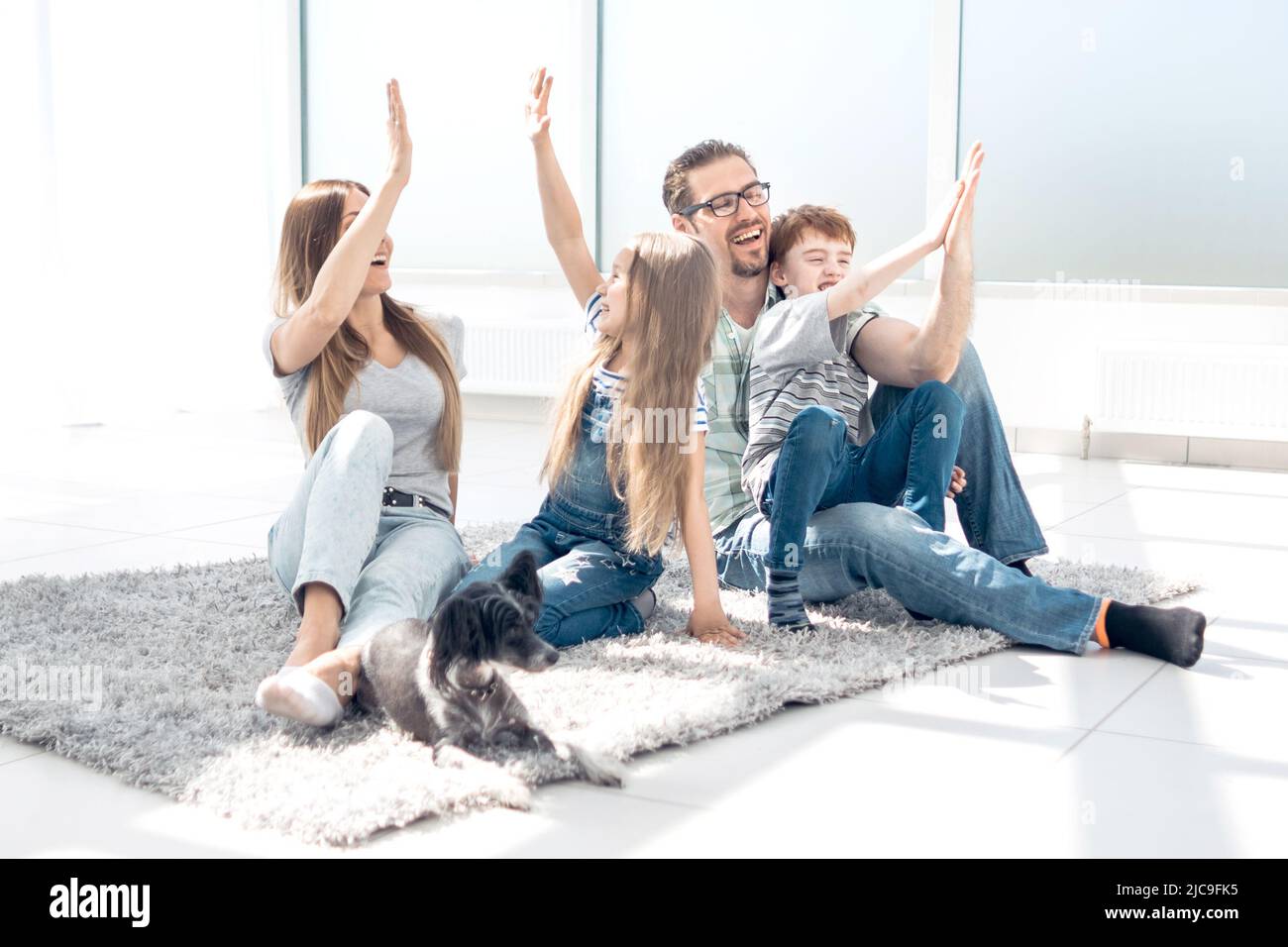 happy family with kids giving each other a high five Stock Photo - Alamy