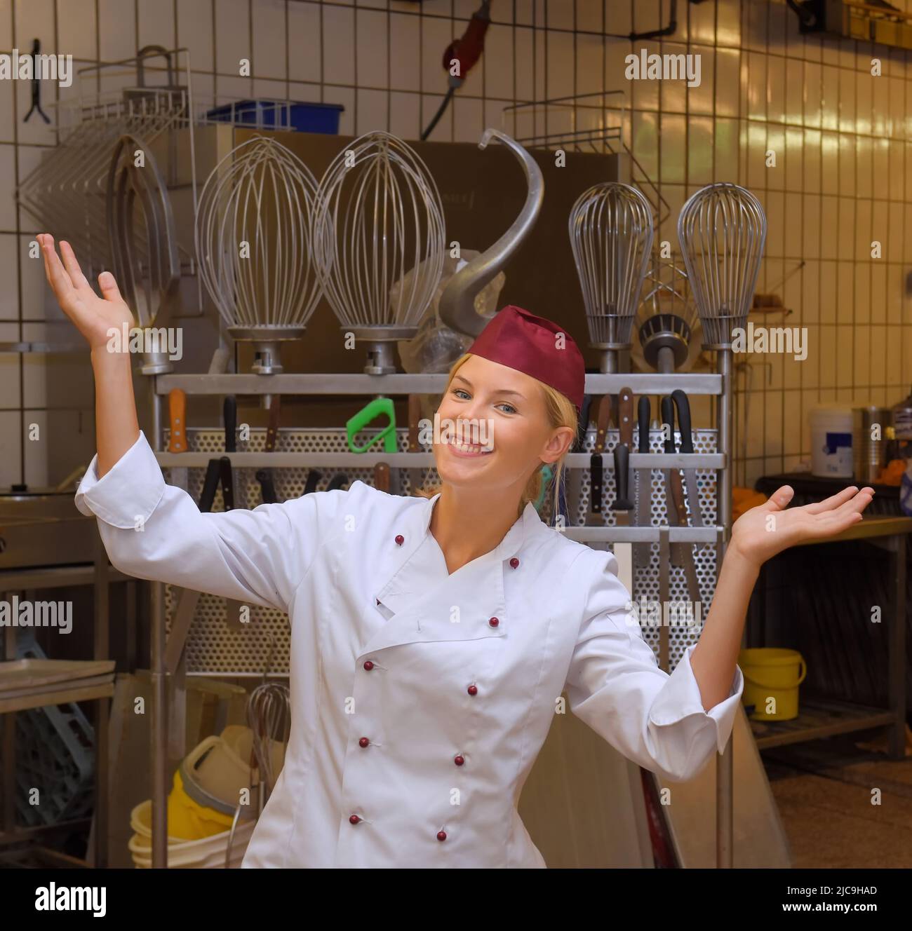 A young baker girl takes up her work in a bakery. She is seen in the ...