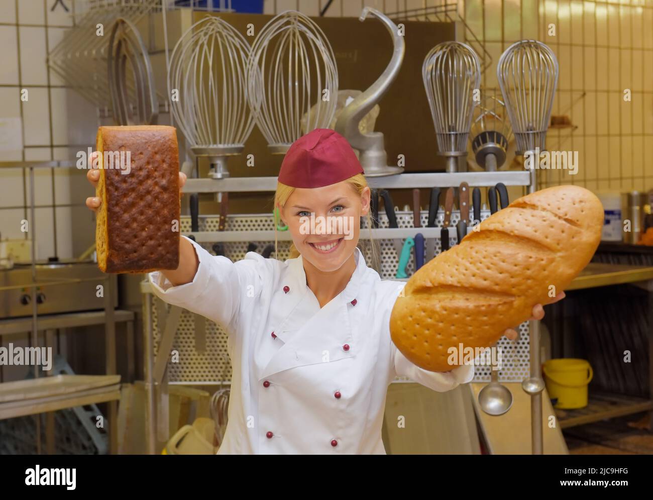 A young baker girl takes up her work in a bakery. She is seen in the ...