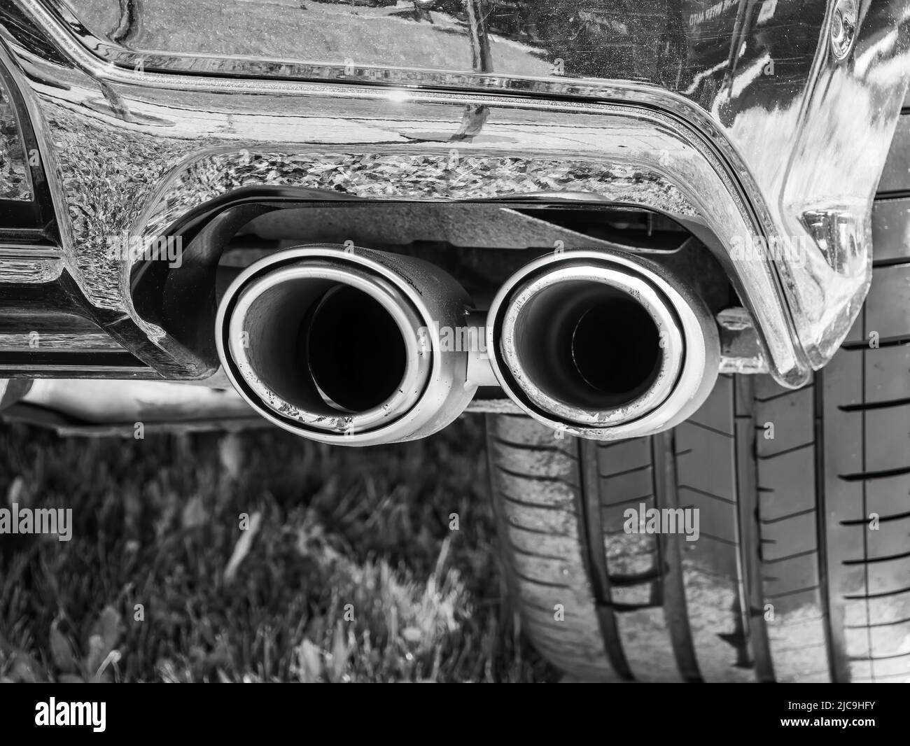 Monochrome close up picture with a double exhaust pipe Stock Photo - Alamy