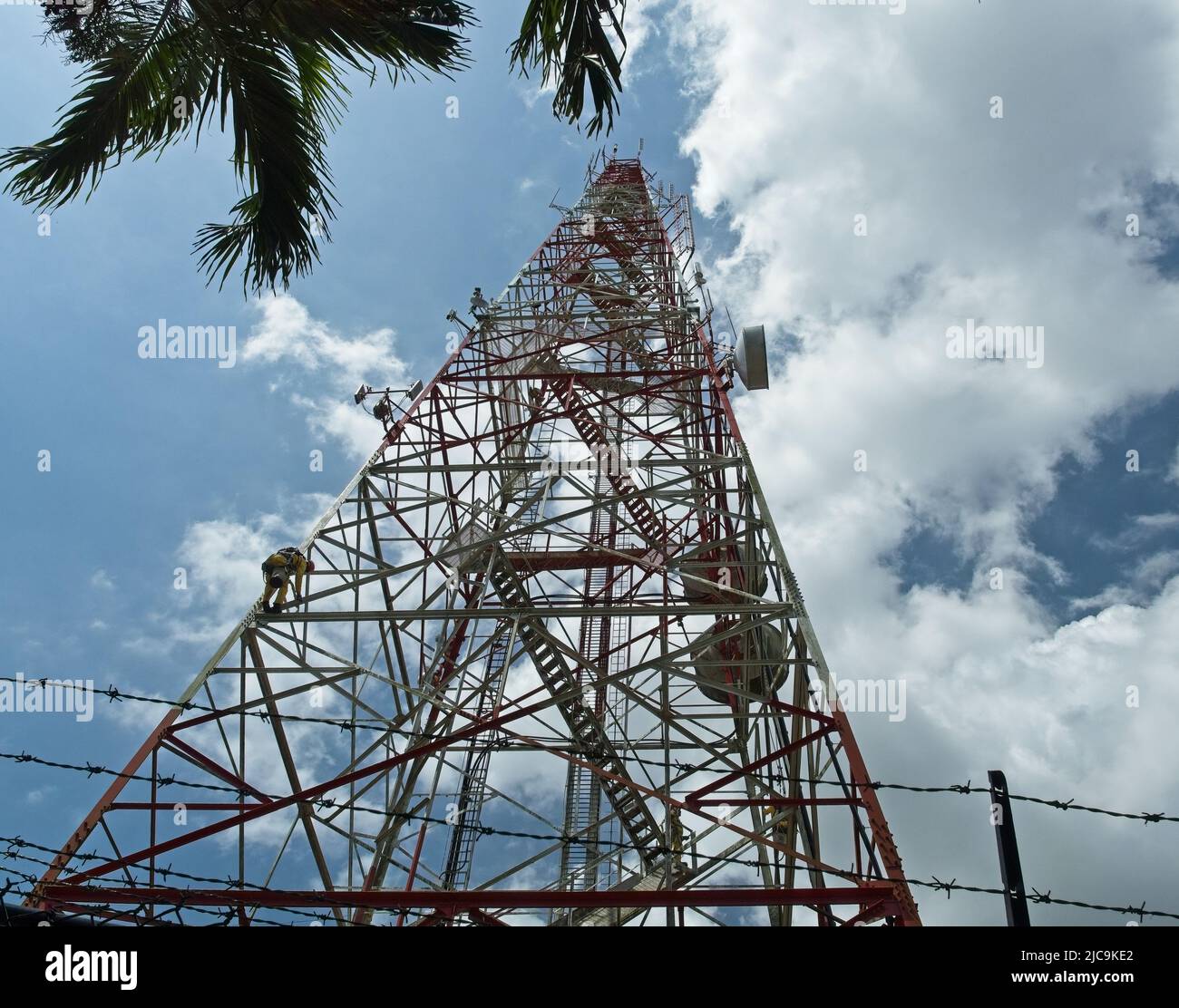 A maintenance worker on a communication tower Stock Photo - Alamy