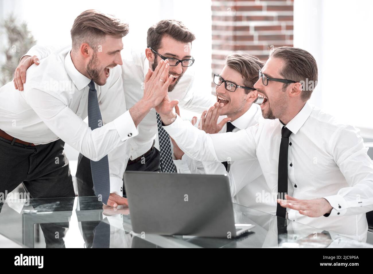 Happy excited business team, gives each other a high five Stock Photo ...