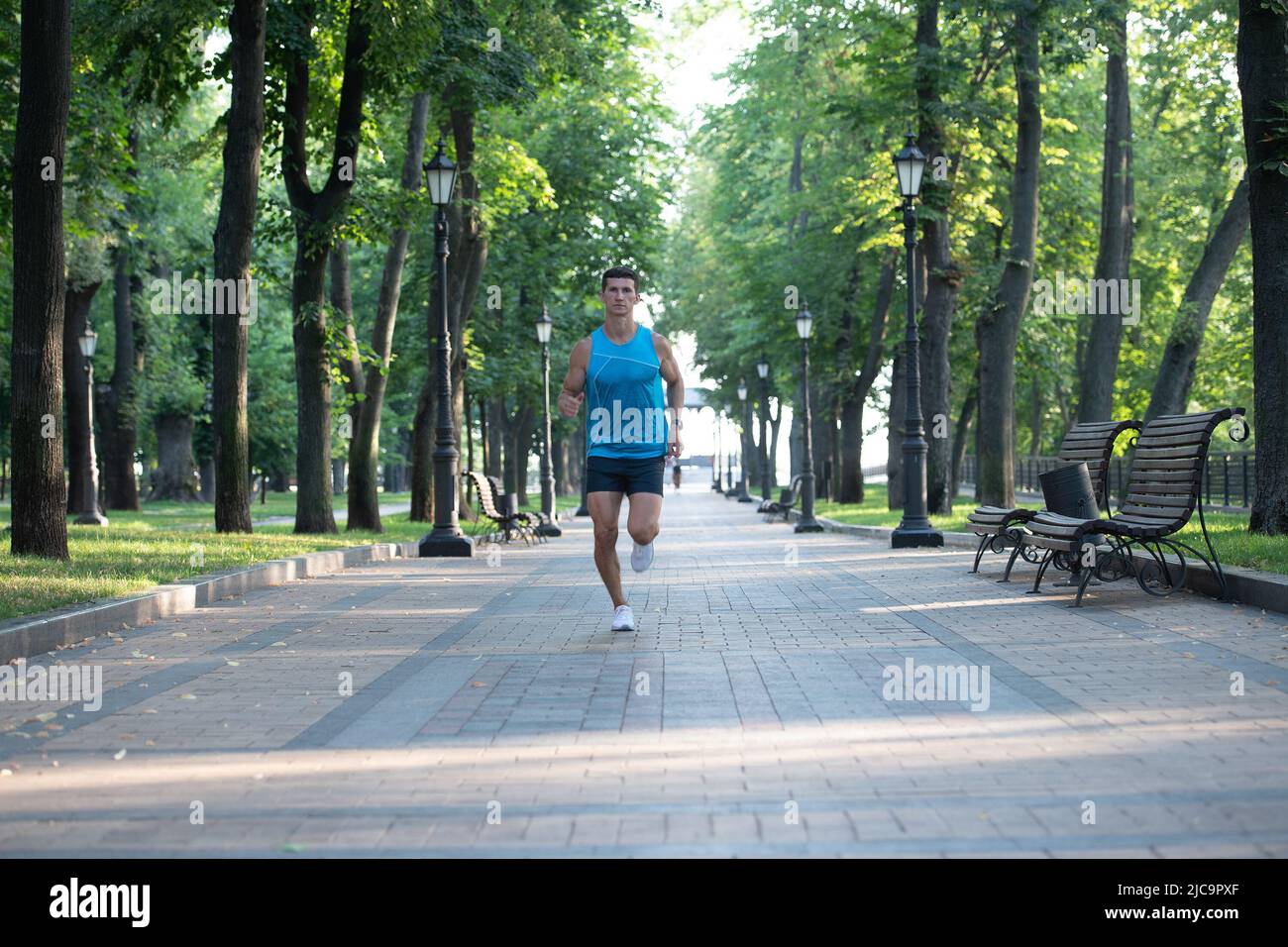 athletic man runner with fit body running in sportswear outdoor Stock ...