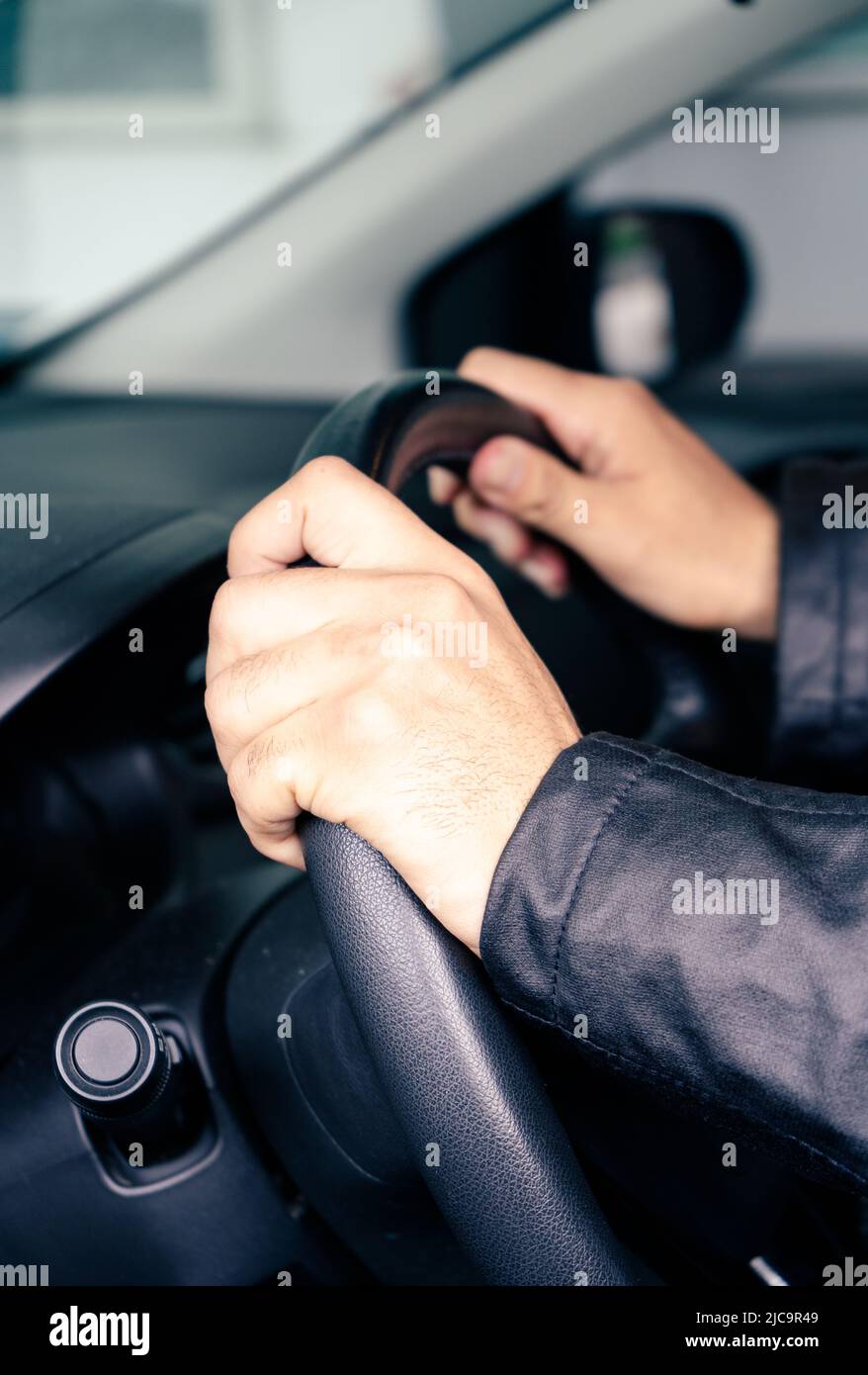 Hands taking the wheel of a car. Transportation and success concept ...