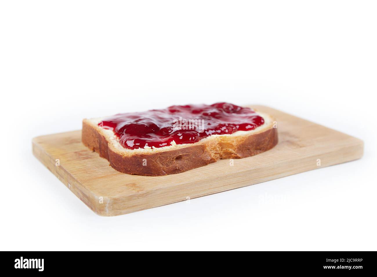 a piece of white bread with strawberry jam, isolated on white ...