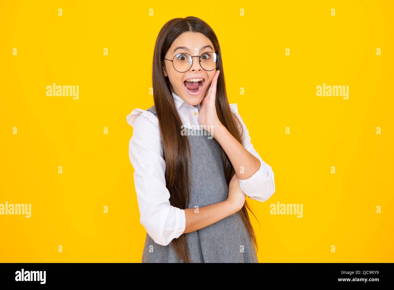 Shocked teenager child with amazed look on yellow background, amazement ...