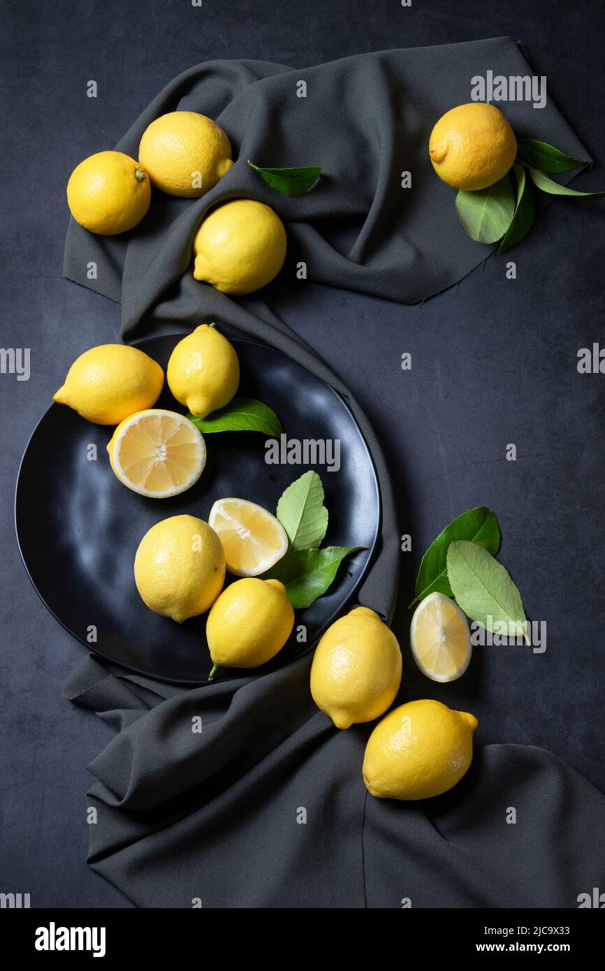 Raw fresh lemons on dark background. Harvest, agricultural concept ...