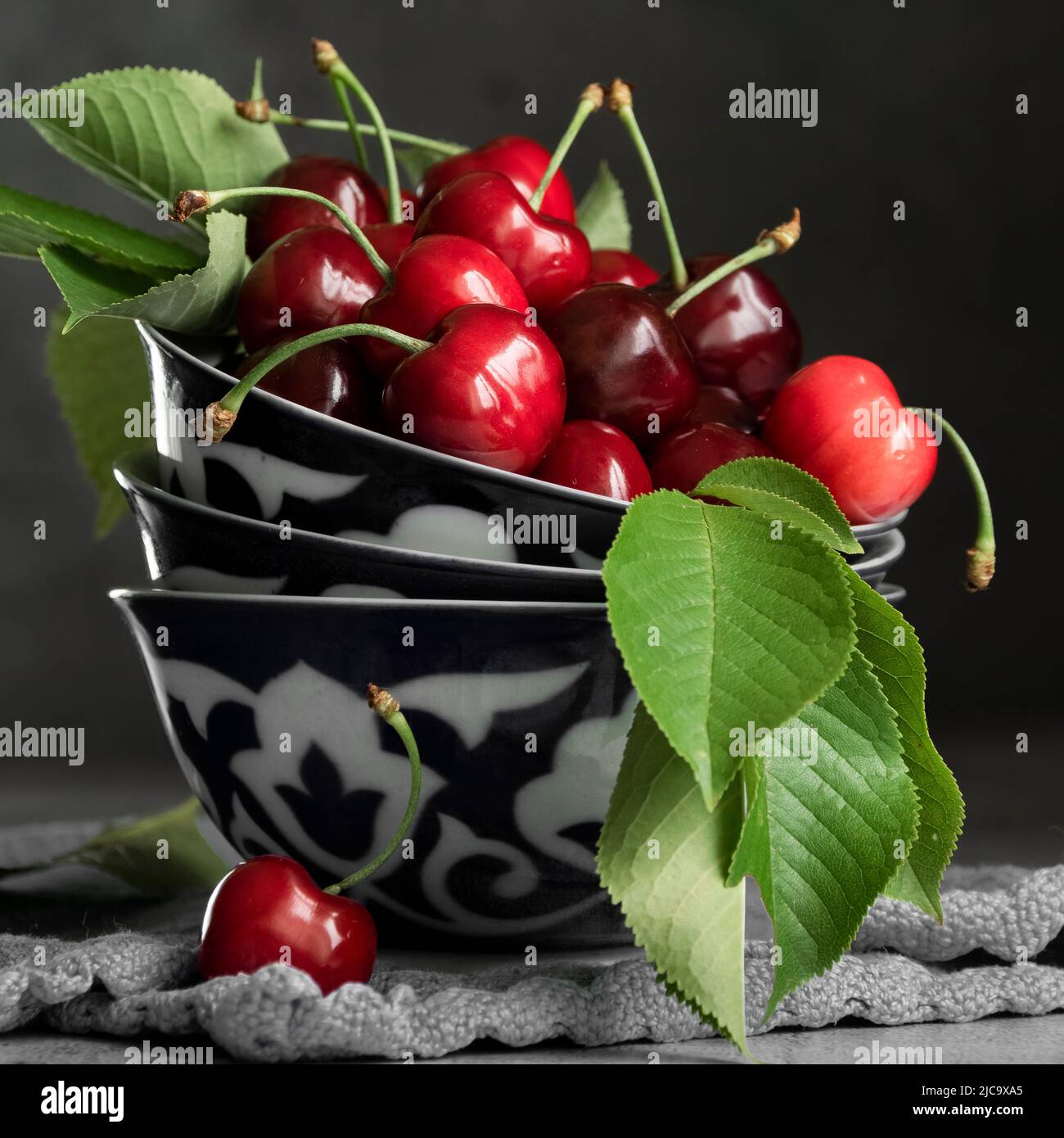 Fresh picked cherries in antique plates, dark food photography Stock ...