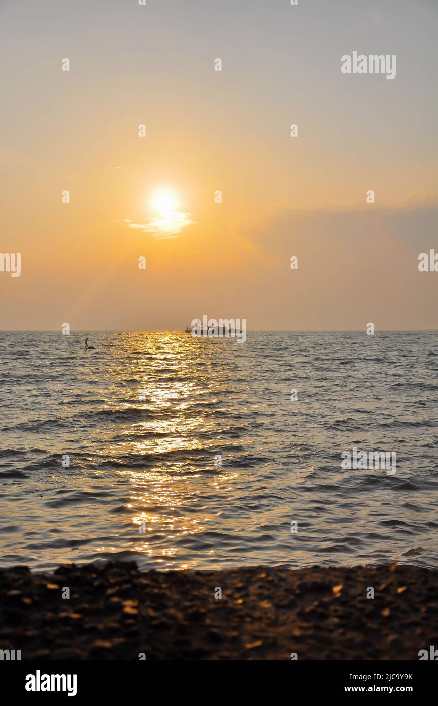 A beautiful sunrise and a sunny path on the water surface in ...