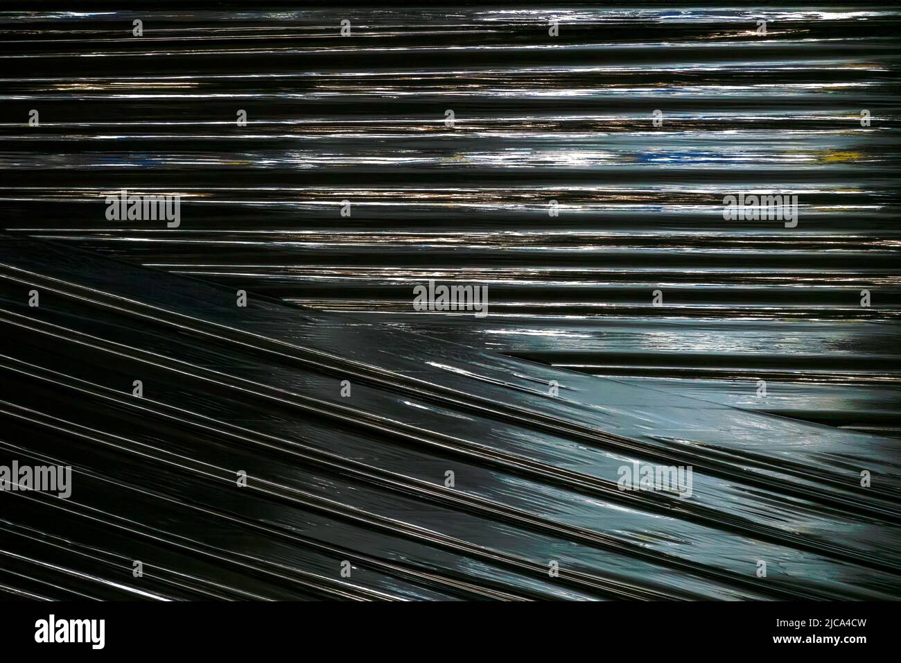 Black plastic wrap background. Crumpled wrinkled plastic cellophane ...