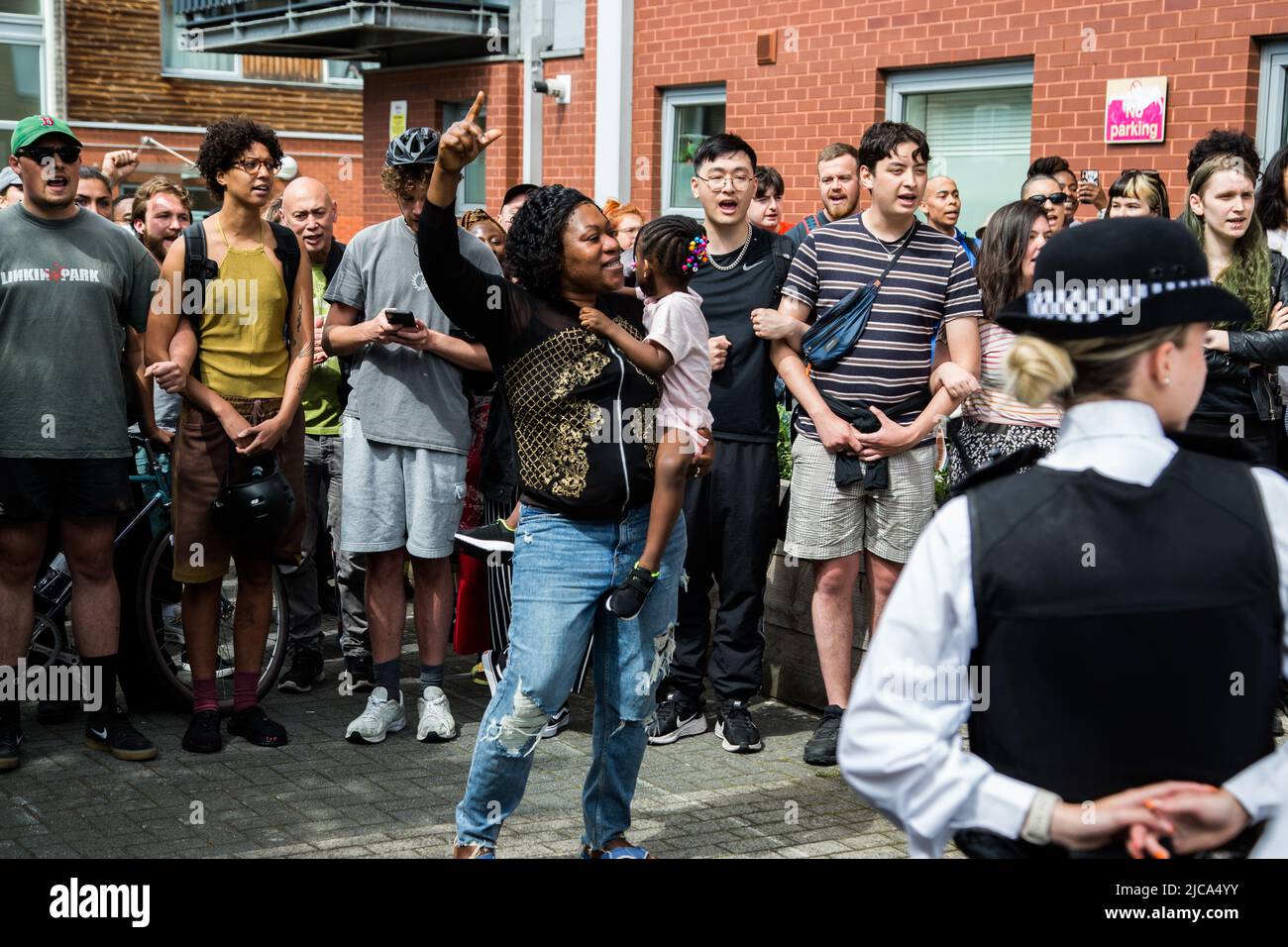 London, UK. 11th June 2022. People stand in front of a immigration van ...