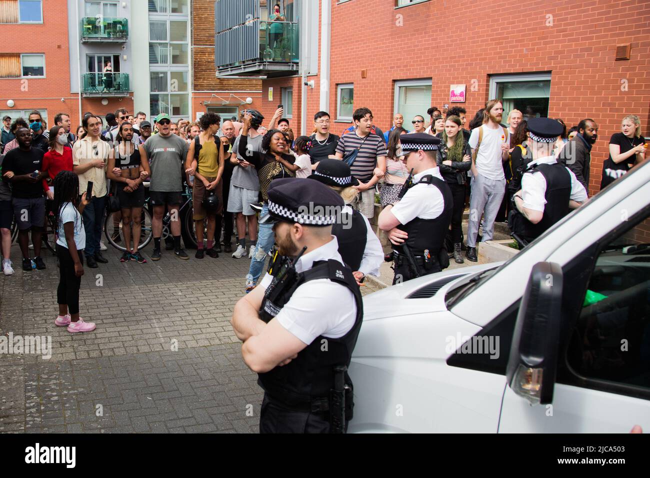 London, UK. 11th June 2022. People stand in front of a immigration van ...