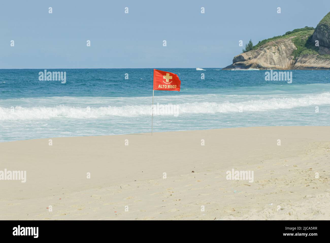 red current signaling flag, written high risk on a beach in Rio de ...