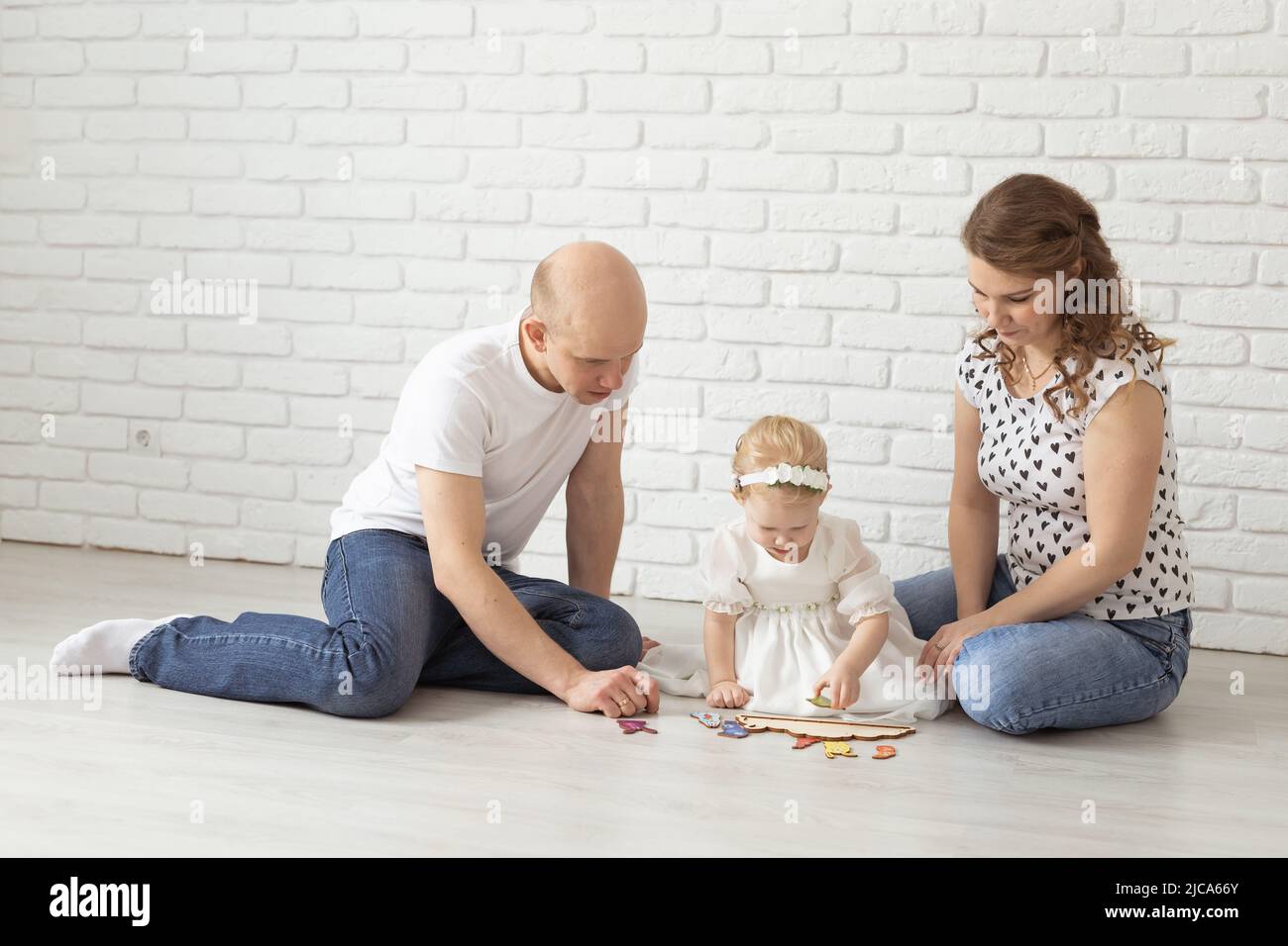 Baby child with hearing aids and cochlear implants plays with parents ...