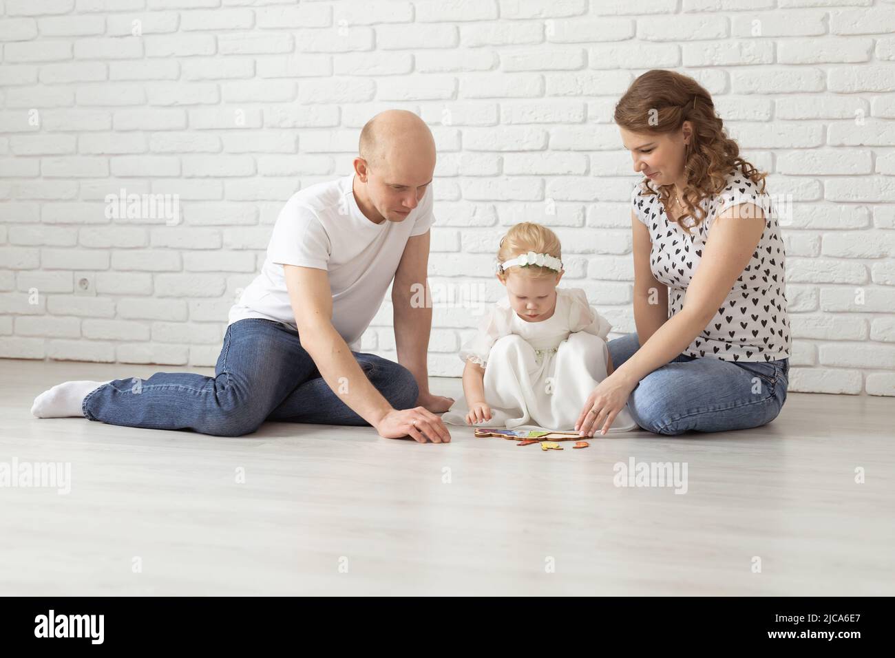 Baby child with hearing aids and cochlear implants plays with parents ...