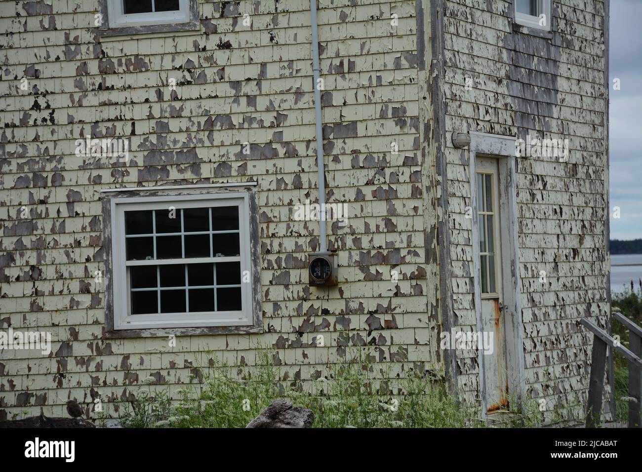 Window and yellow siding at old seaside building Stock Photo - Alamy