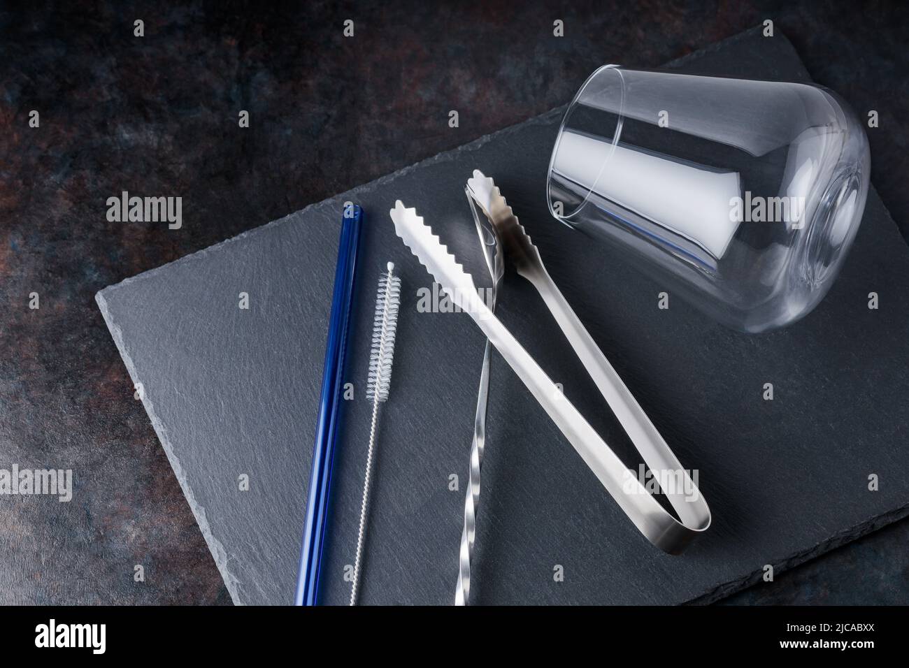 Cocktail making tools and glass on slate board. Bar tools: cocktail ...