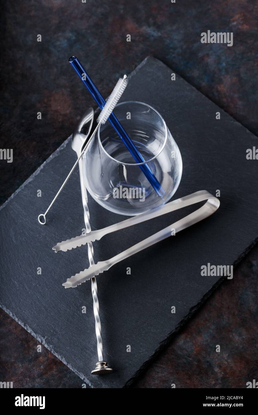 Cocktail making tools and glass on slate board. Bar tools: cocktail ...