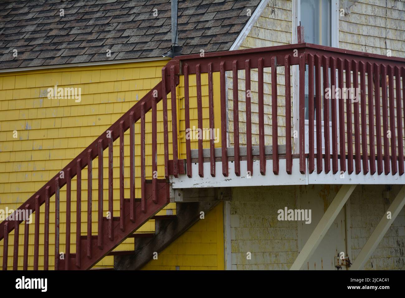 Window and yellow siding at old seaside building Stock Photo - Alamy