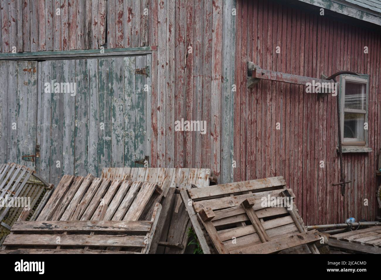 Window and yellow siding at old seaside building Stock Photo - Alamy