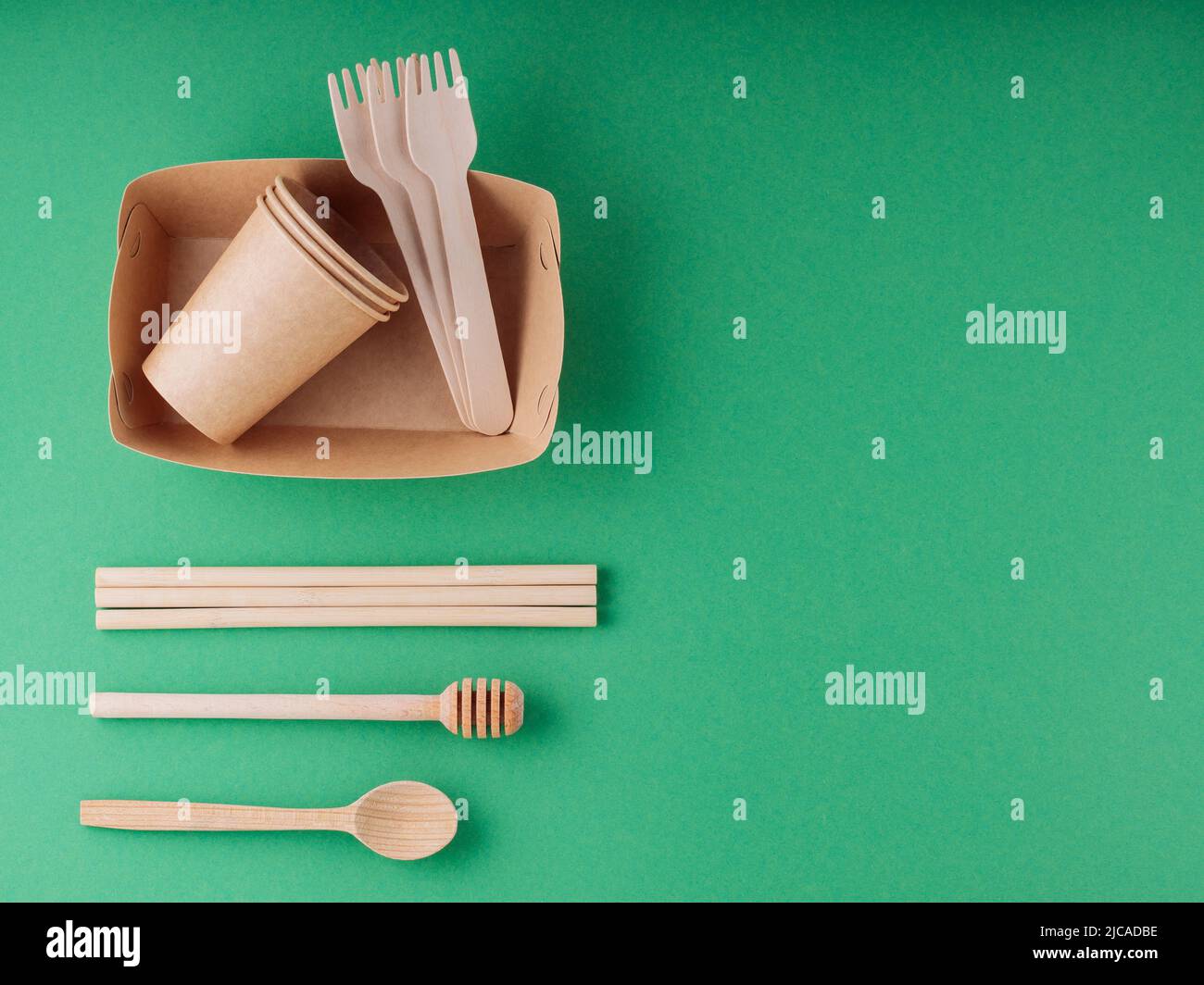 Eco-friendly tableware, paper disposable cup and wooden cutlery on a ...