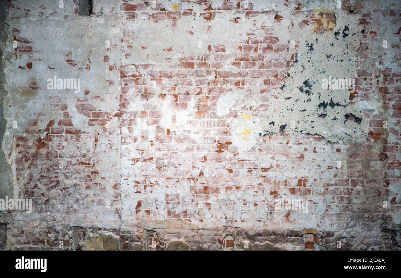 Dilapidated building facade with damaged plaster. Vintage brick wall ...