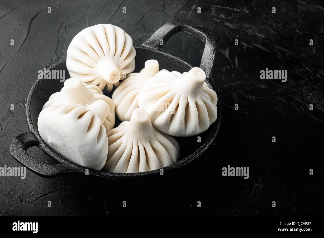 Frozen Raw dumplings Khinkali with beef and lamb meat, in frying cast ...
