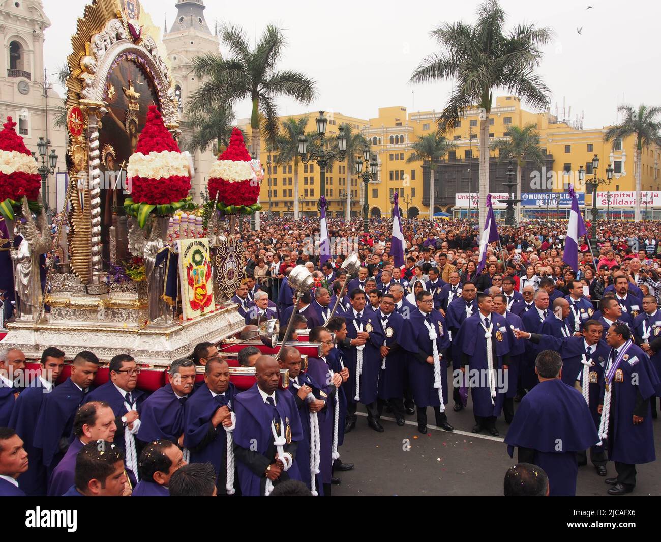 Tens of thousands of devotees in procession carrying on their shoulders ...