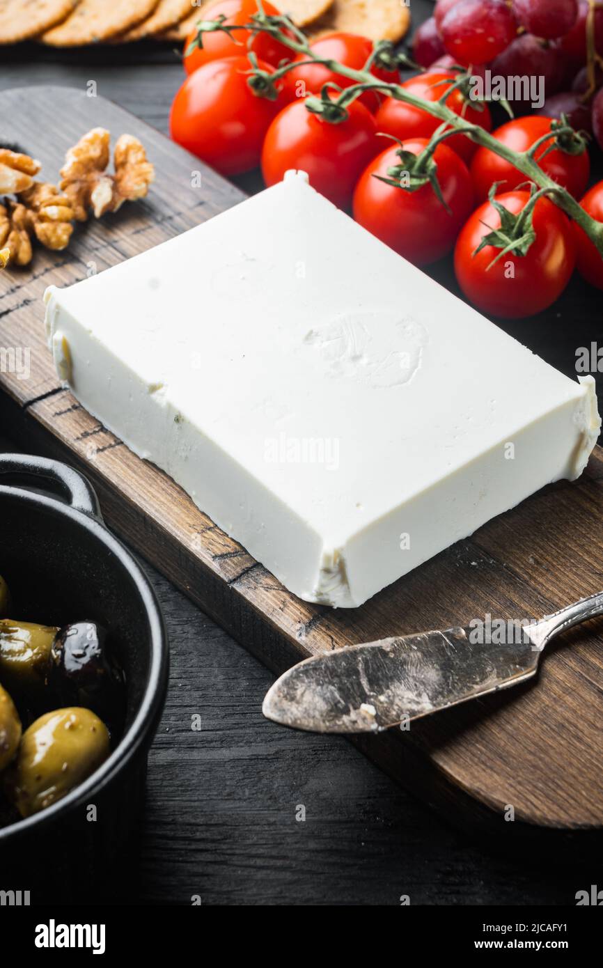 Traditional greek feta cheese, on black wooden table Stock Photo - Alamy