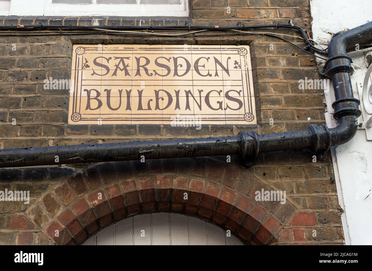 Starsden buildings sign made out of tiles on a brick wall of apartment ...