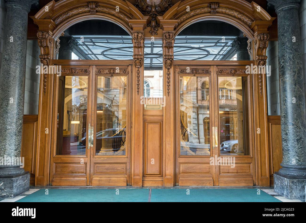 Main entrance large wooden doors of an old Victorian style building of ...