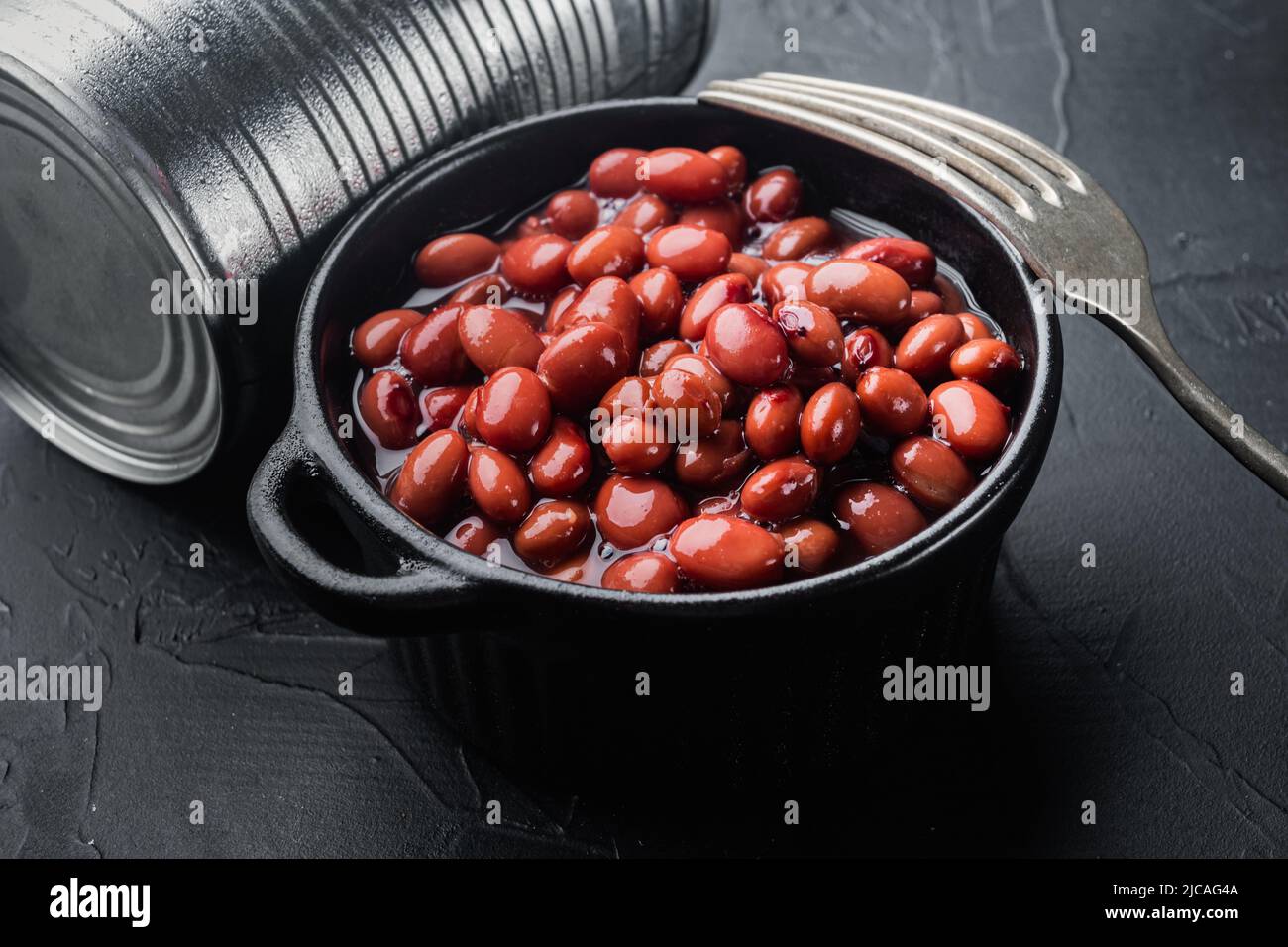 Red bean, canned food, on black background Stock Photo - Alamy