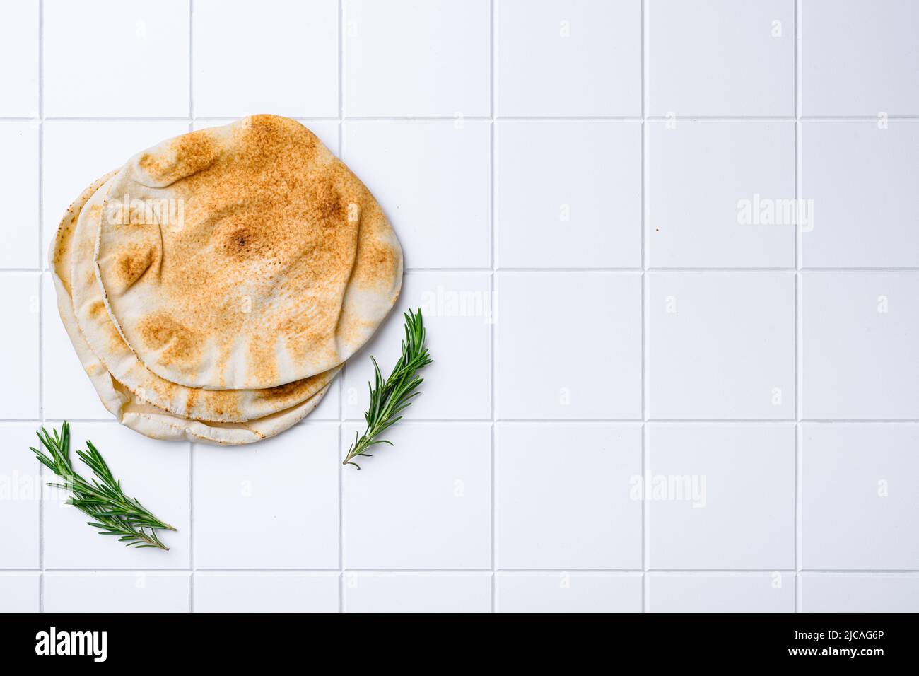 Pita flat bread set, on white ceramic squared tile table background ...