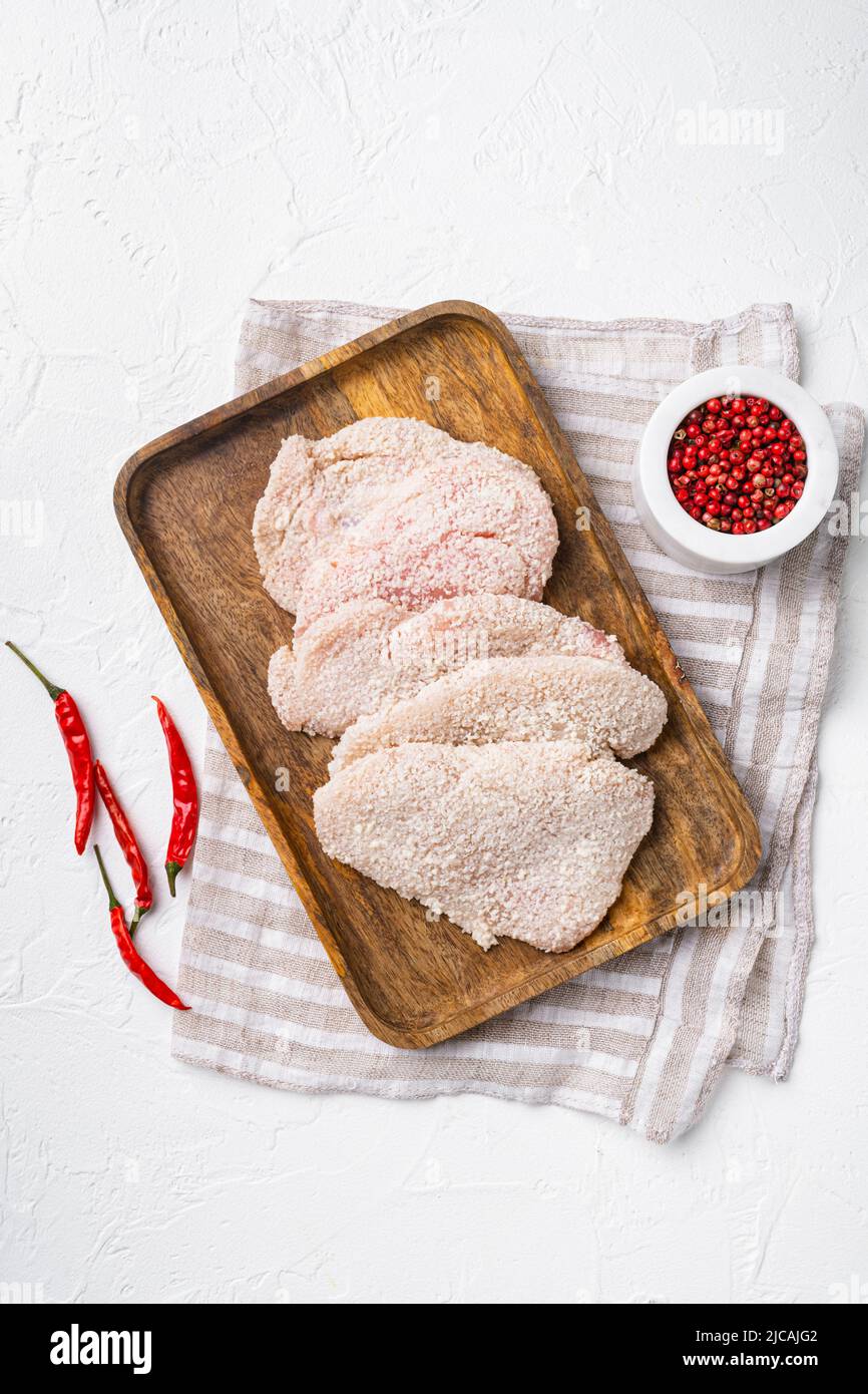 Raw schnitzel chicken meat set, on white stone table background, top ...