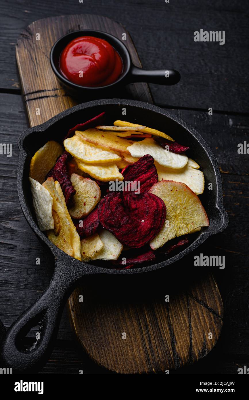 Dried vegetables chips, on black wooden table background Stock Photo ...