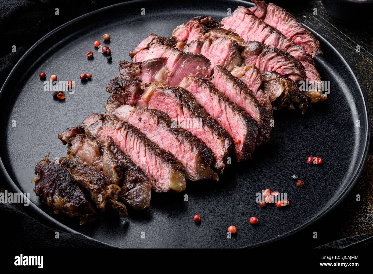 Sliced grilled rib eye beef steak beef marbled rare, on plate, on old ...