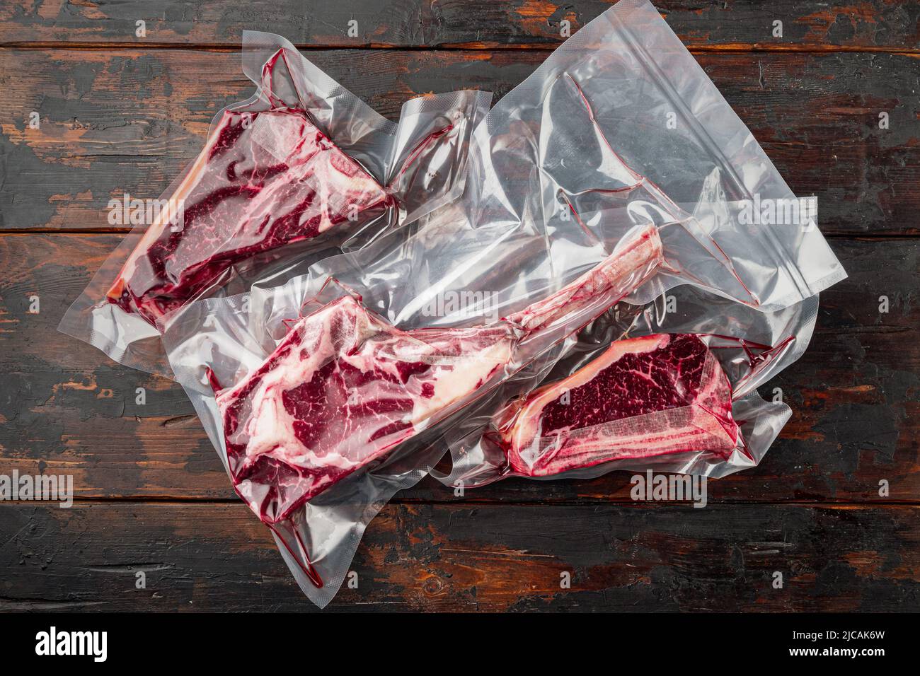 Raw uncooked beef steaks in vacuum packed air sealed sous vide bag ...