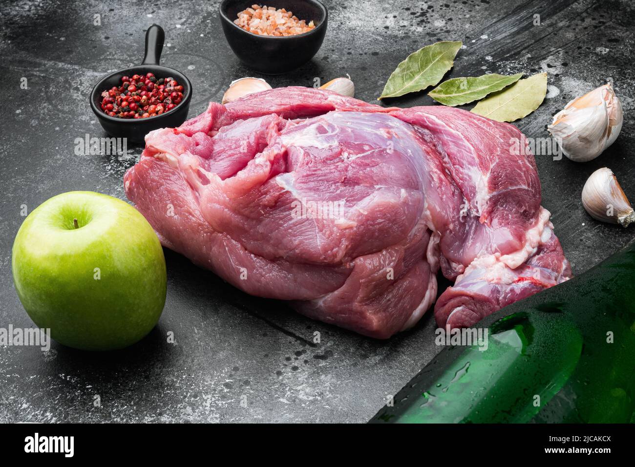 Pork roast ingredients, with apple dry cider, on black dark stone table ...