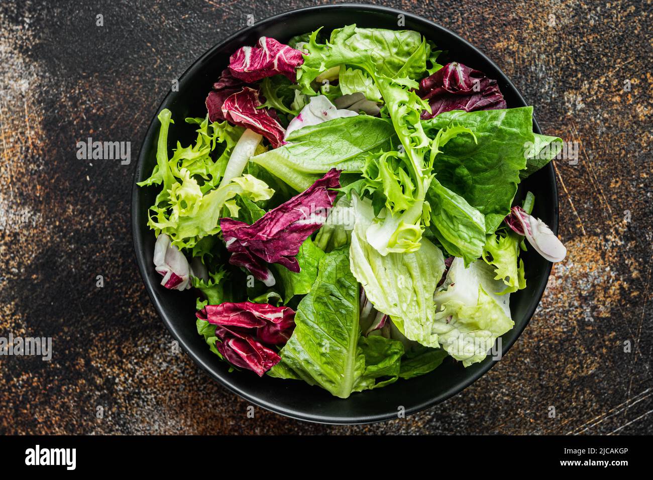 Frieze, romaine and Radicchio lettuce, on old dark rustic background ...
