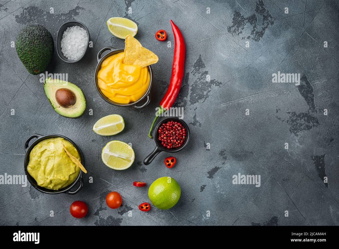 Green guacamole and yellow cheese dip sauce for traditional Mexican ...