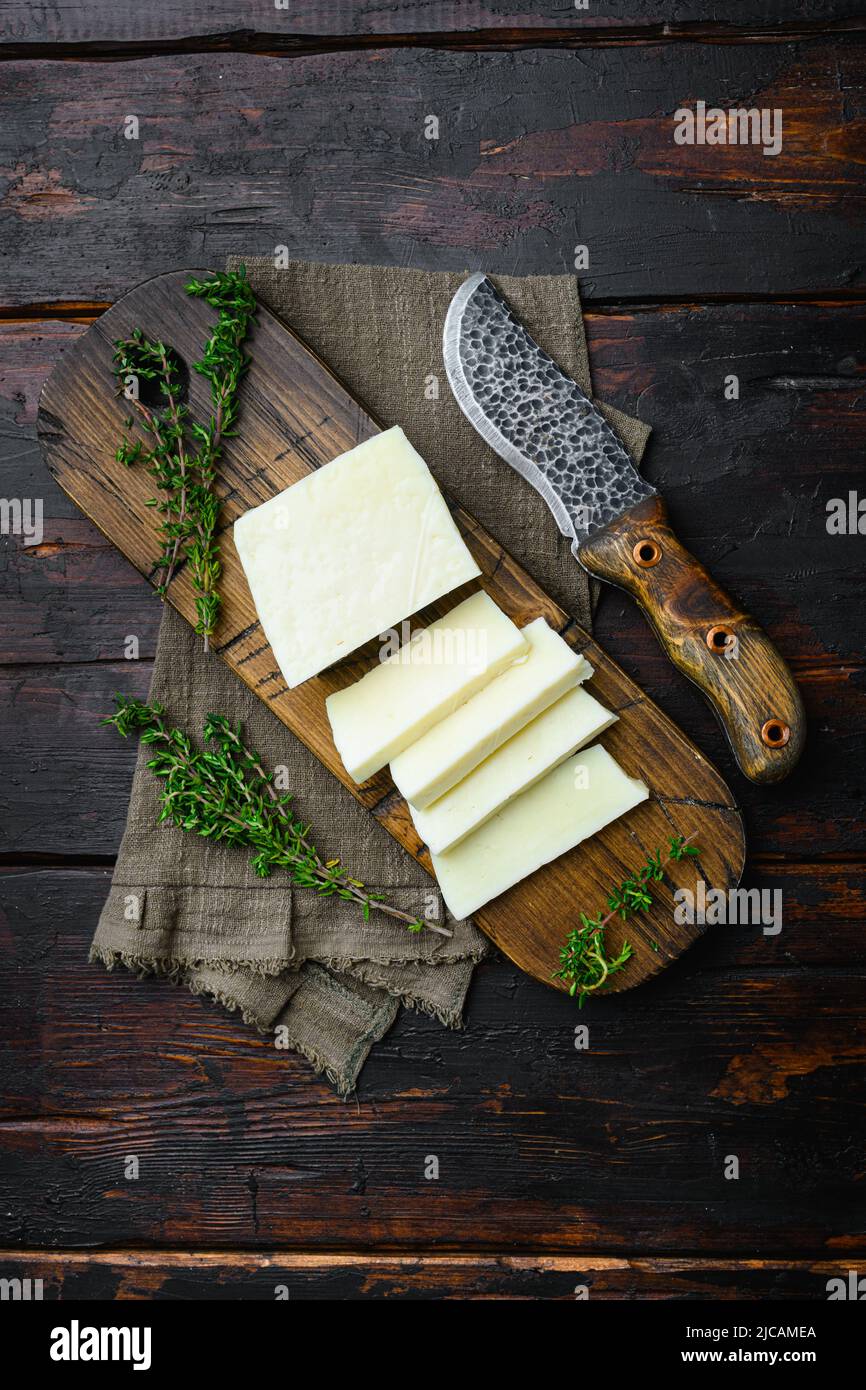 Fresh halloumi cheese set, on old dark wooden table background, top ...