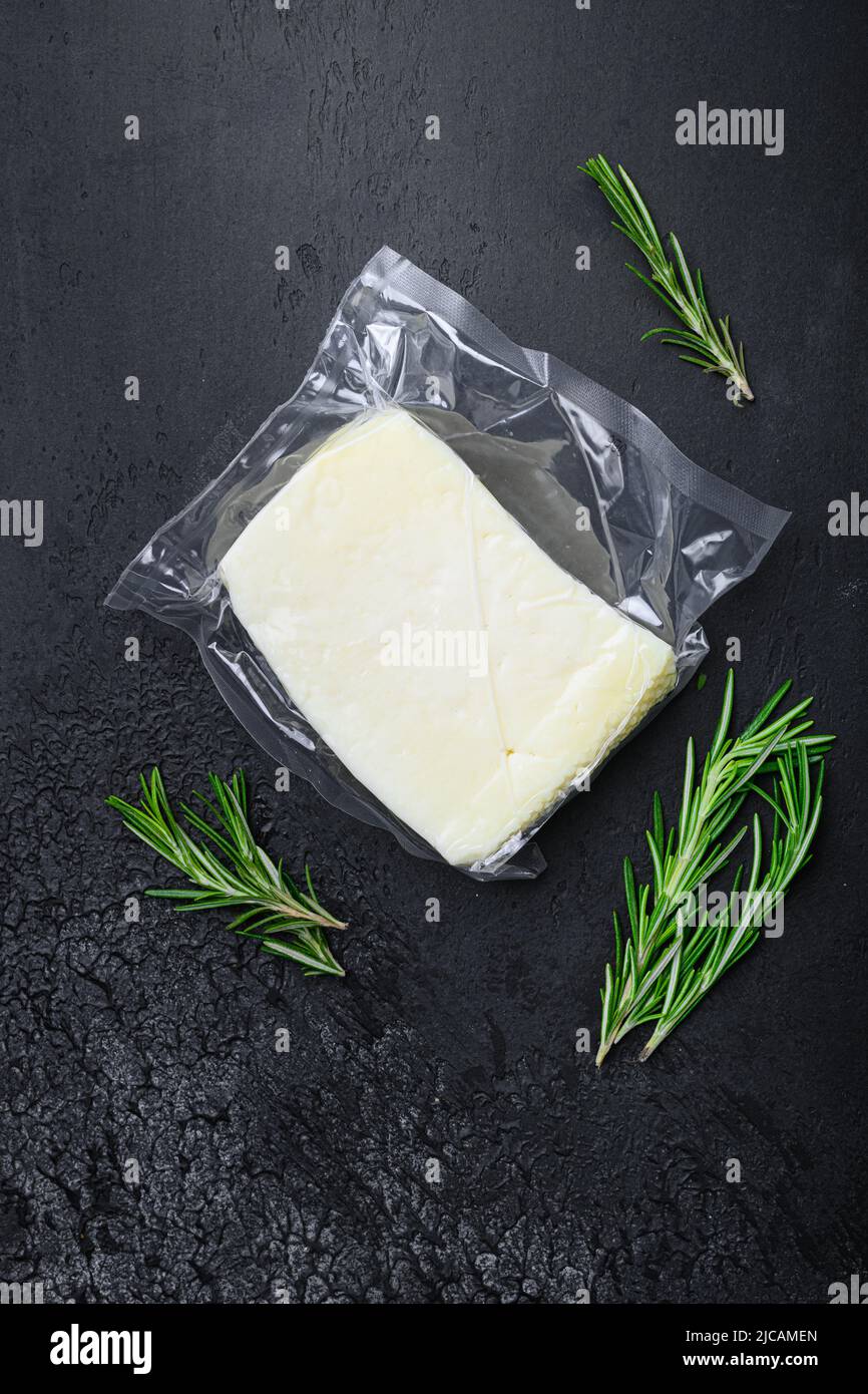 Fresh halloumi cheese set, on black dark stone table background, top ...