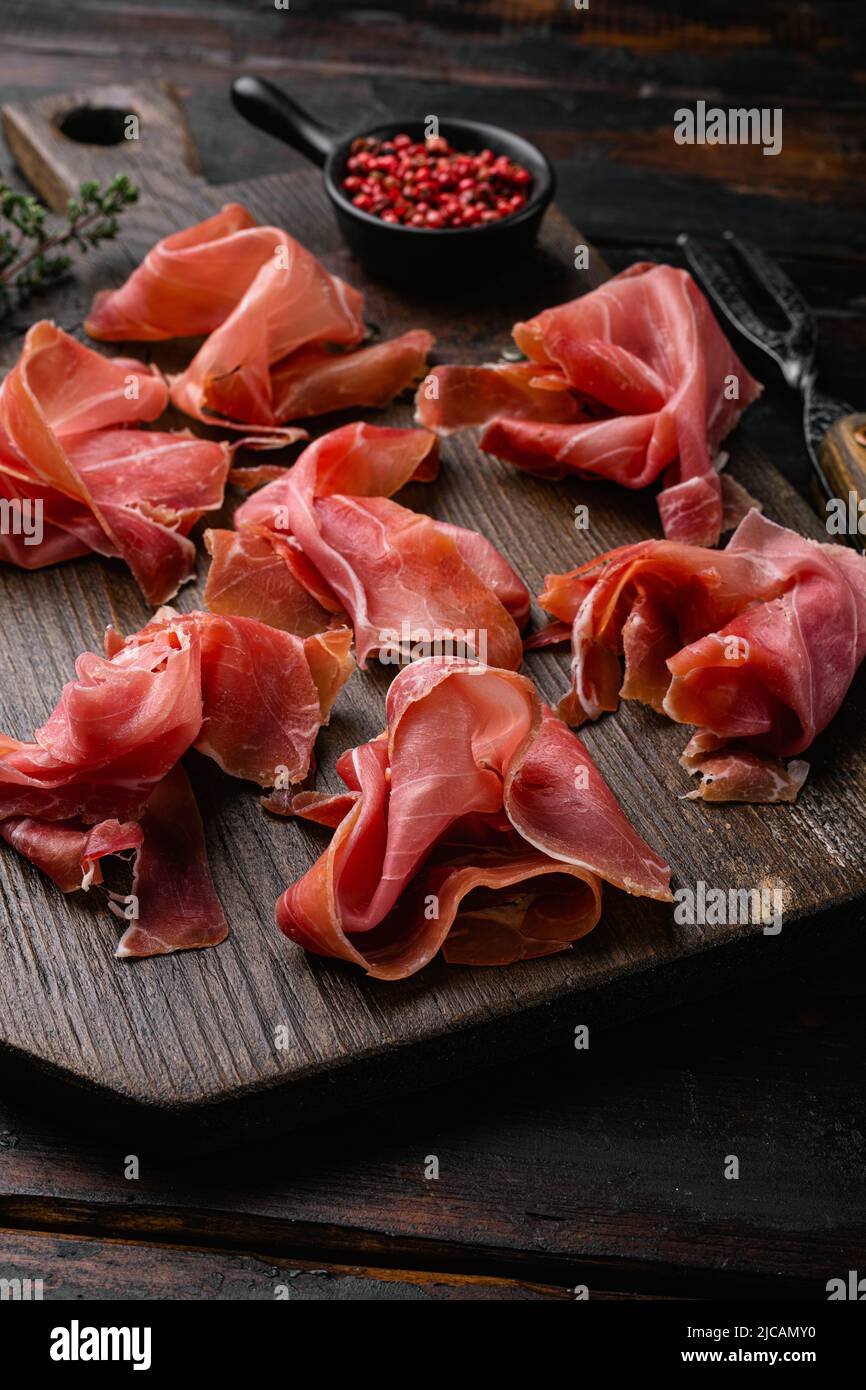 Jamon serrano. Traditional Spanish ham set, on old dark wooden table ...