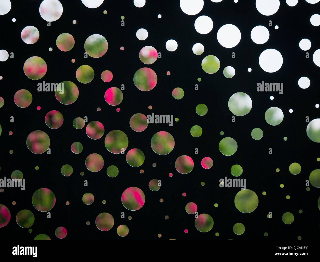 Black Wall with Circular Holes of Different Sizes Stock Photo - Alamy