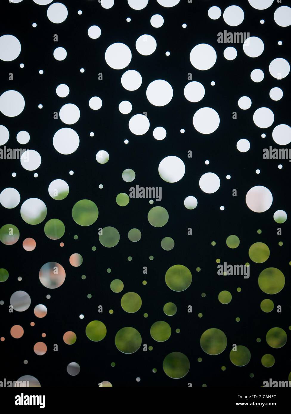 Black Wall with Circular Holes of Different Sizes Stock Photo - Alamy