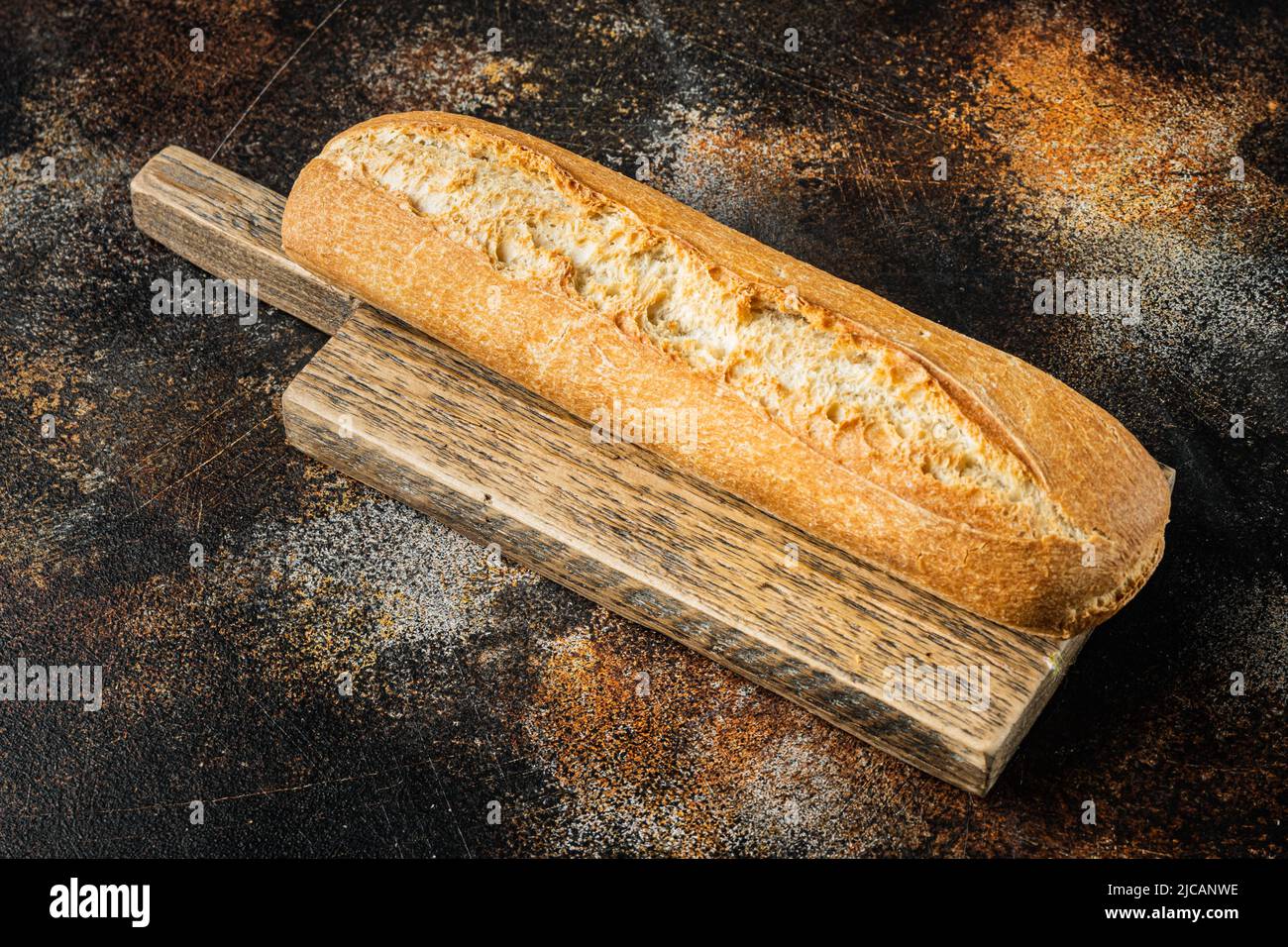Freshly baked baguette, on old dark rustic background Stock Photo - Alamy