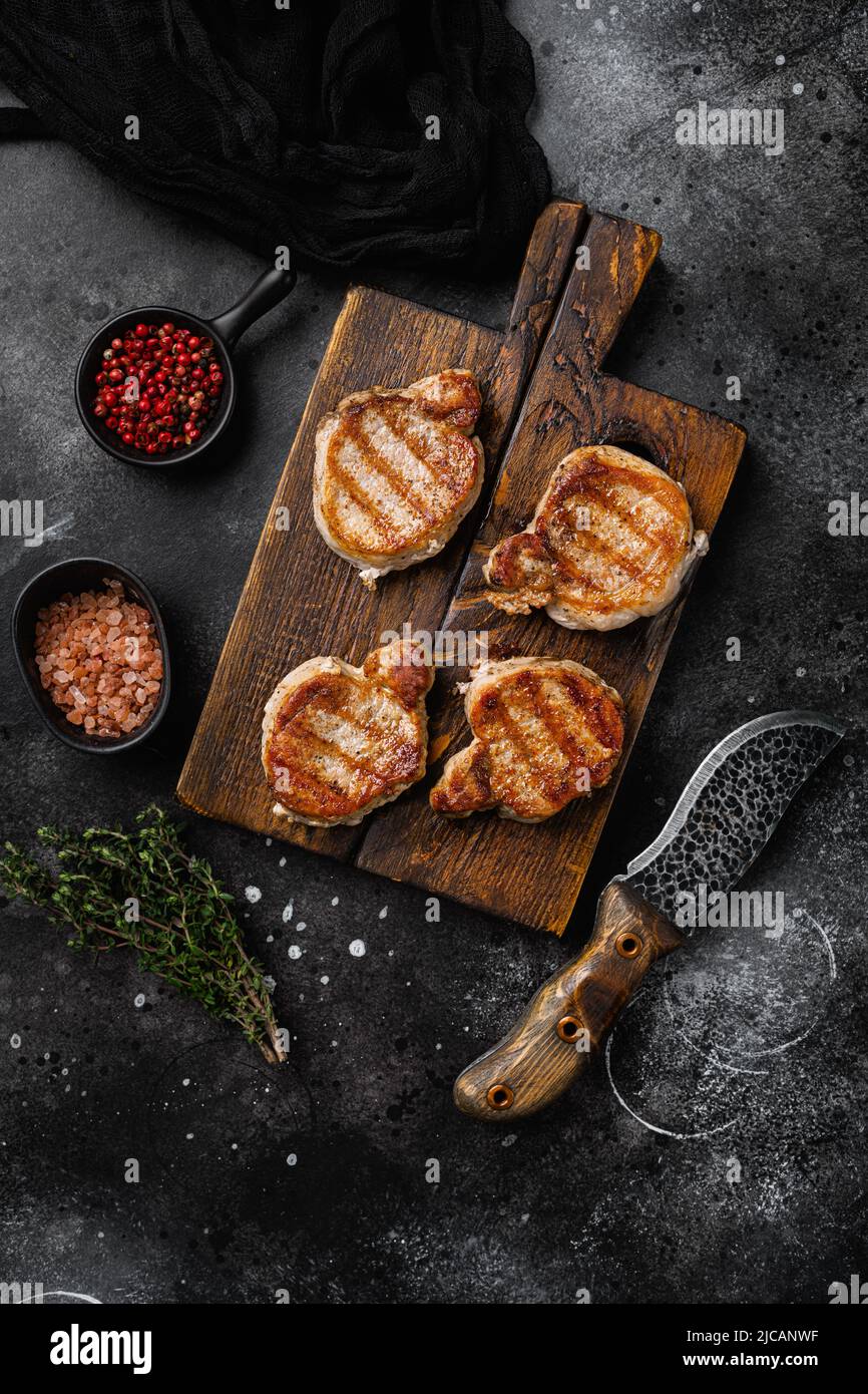 Grilled pork fillet meat, on black dark stone table background, top ...