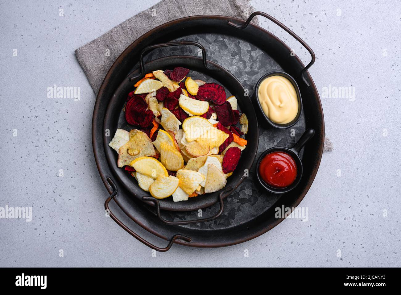 Root Vegetable Crisps, on gray stone table background, top view flat ...